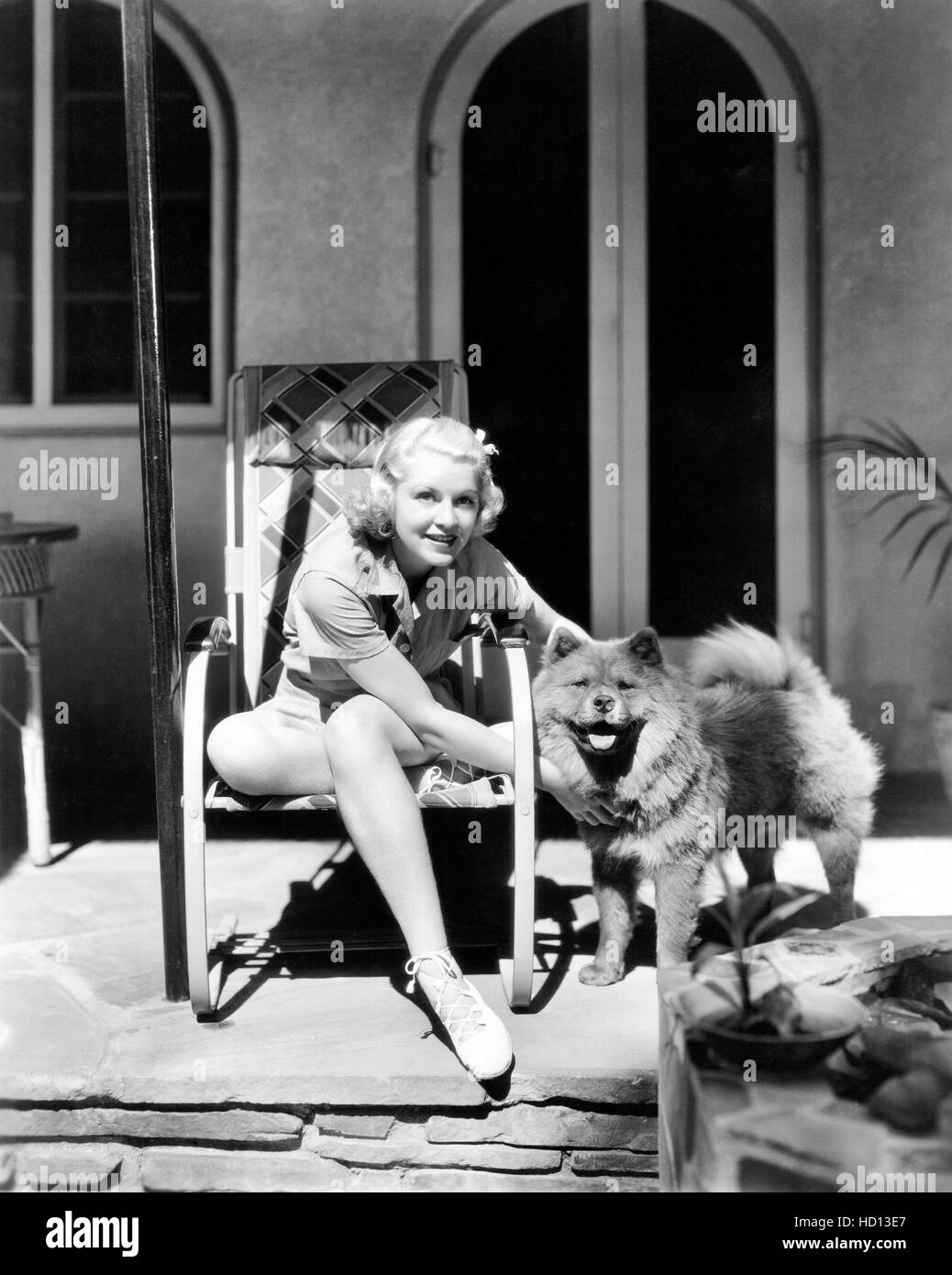 Claire Trevor posing with her pet chow, Wolfie, 1935. ©20th Century-Fox ...