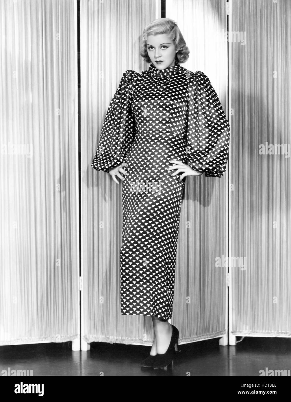 Claire Trevor modeling navy blue and white dress designed by Fox ...