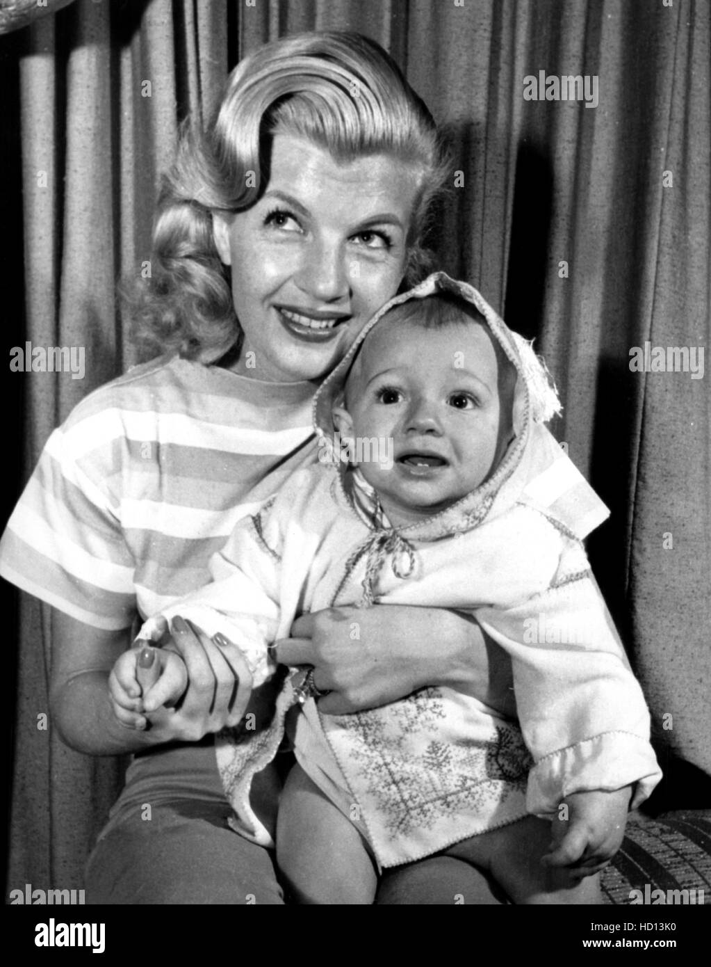 From left: Corinne Calvet posing with nine-month-old son Robin Stone ...