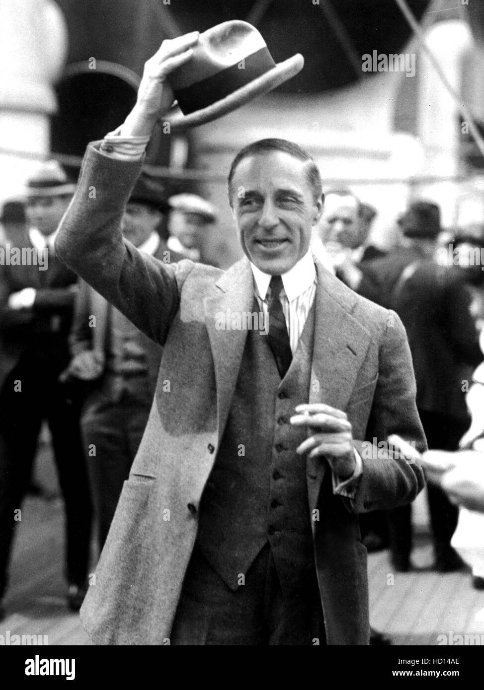 D.W. GRIFFITH, aboard an ocean liner, tips his hat for the ...