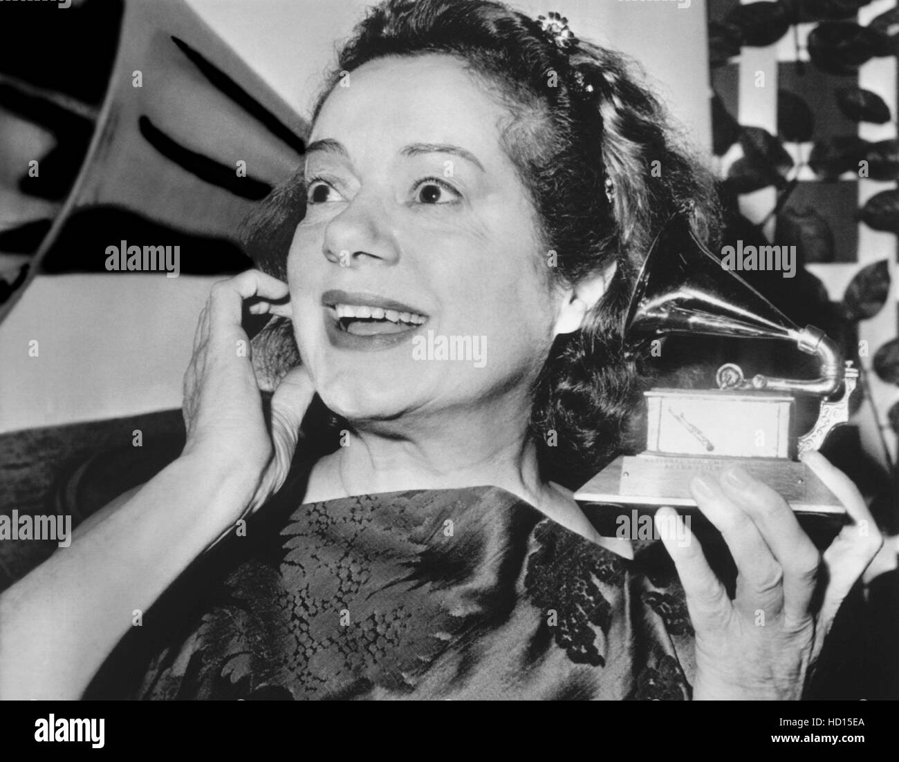 Elsa Lanchester holds up the Grammy award, won by her late husband ...