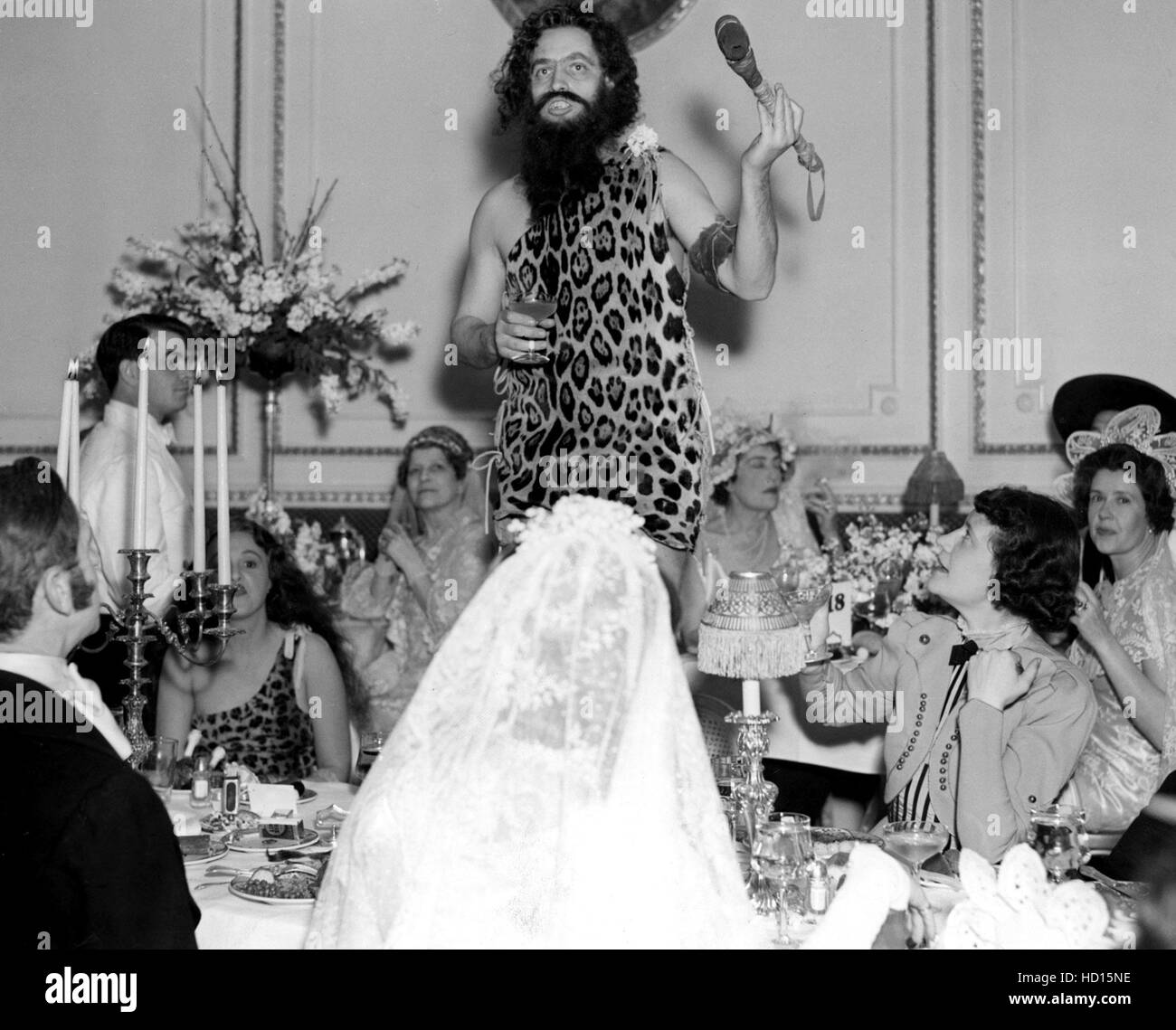 Fredric March in caveman costume and false beard eulogizing host Basil ...