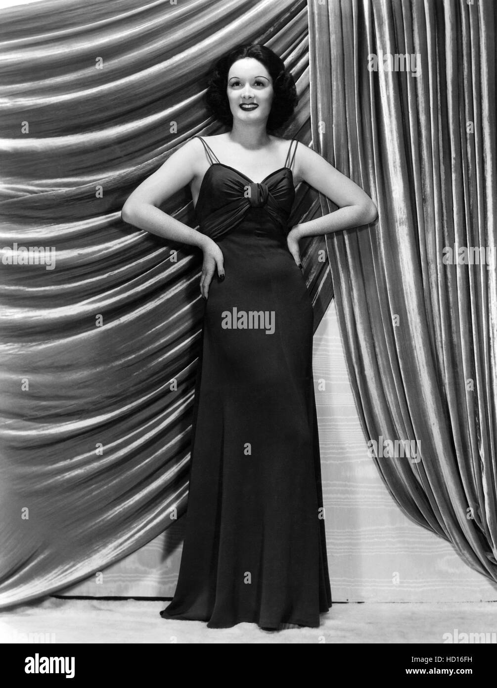 Gail Patrick wearing blue-violet crepe evening gown designed by Edith Head, 1939 Stock Photo - Alamy