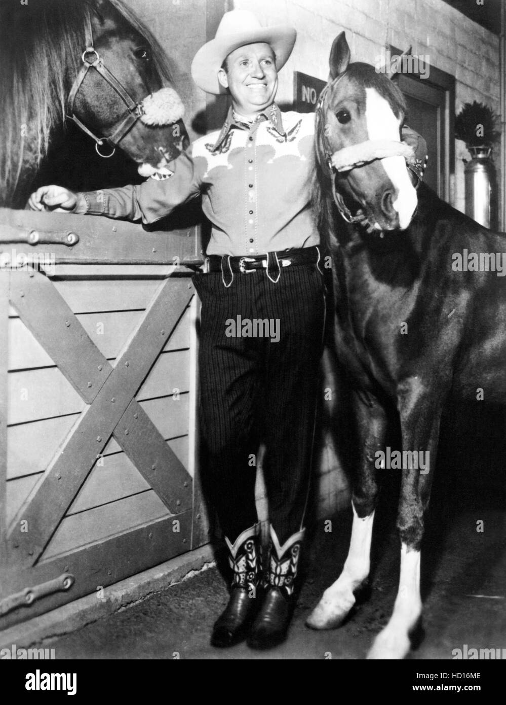 Gene Autry at home in the stable at Melody Ranch, ca. 1951 Stock Photo ...