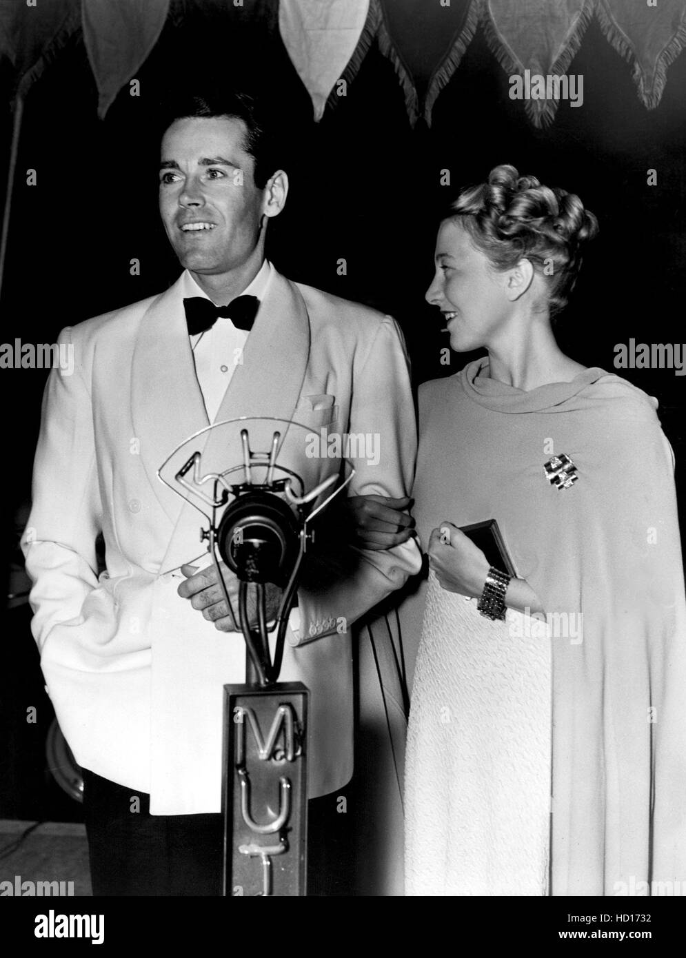 HENRY FONDA and wife FRANCES BROKAW say a few words over a Mutual radio ...