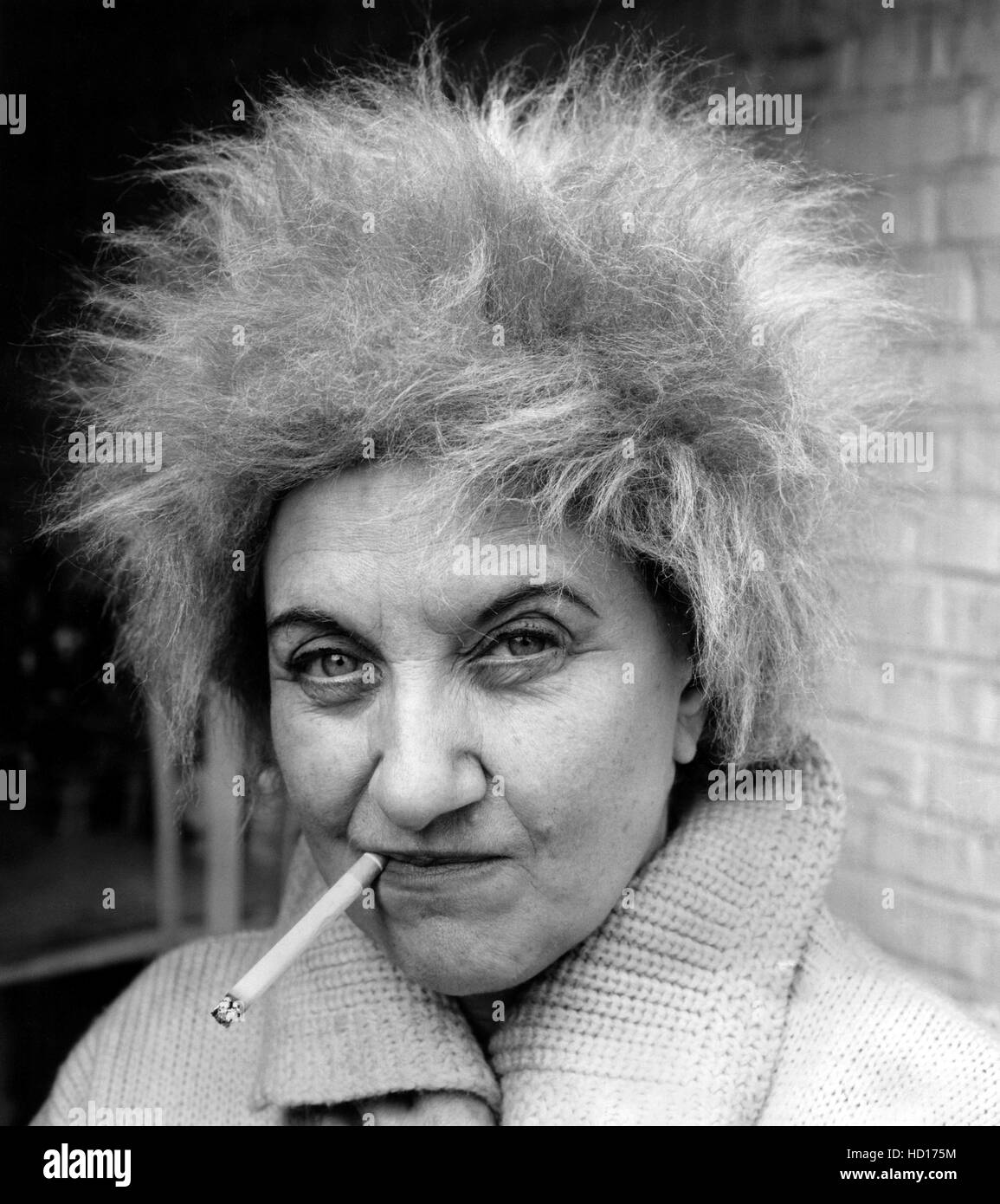 Hermione Gingold modeling a 'wig-warm' hat which can be combed and ...