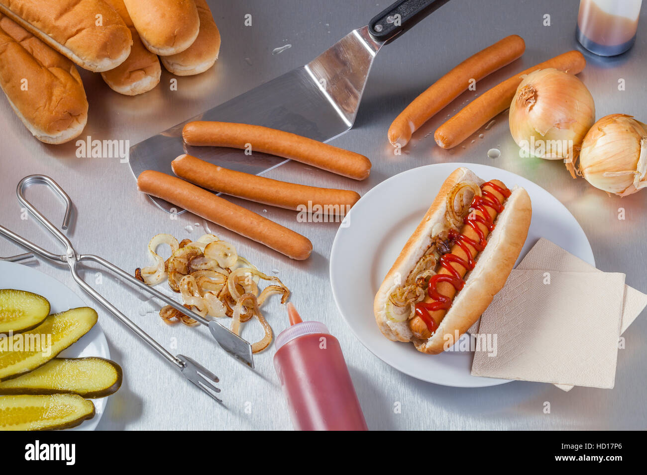 Preparing hot dogs in the stainless steel kitchen of a food truck or ...