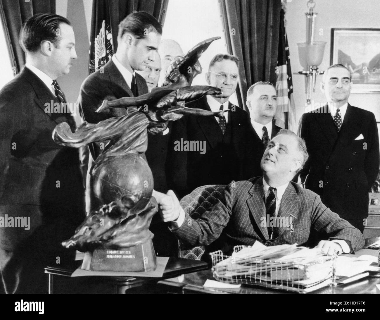 Howard Hughes, (behind eagle), receiving Harmon Trophy from President ...