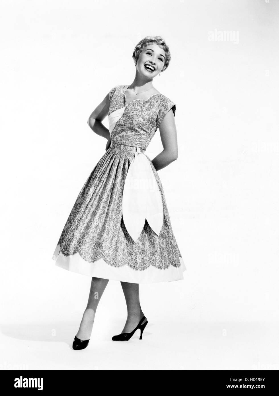 Jane Powell, modeling a summer cocktail dress of black and pink cotton ...