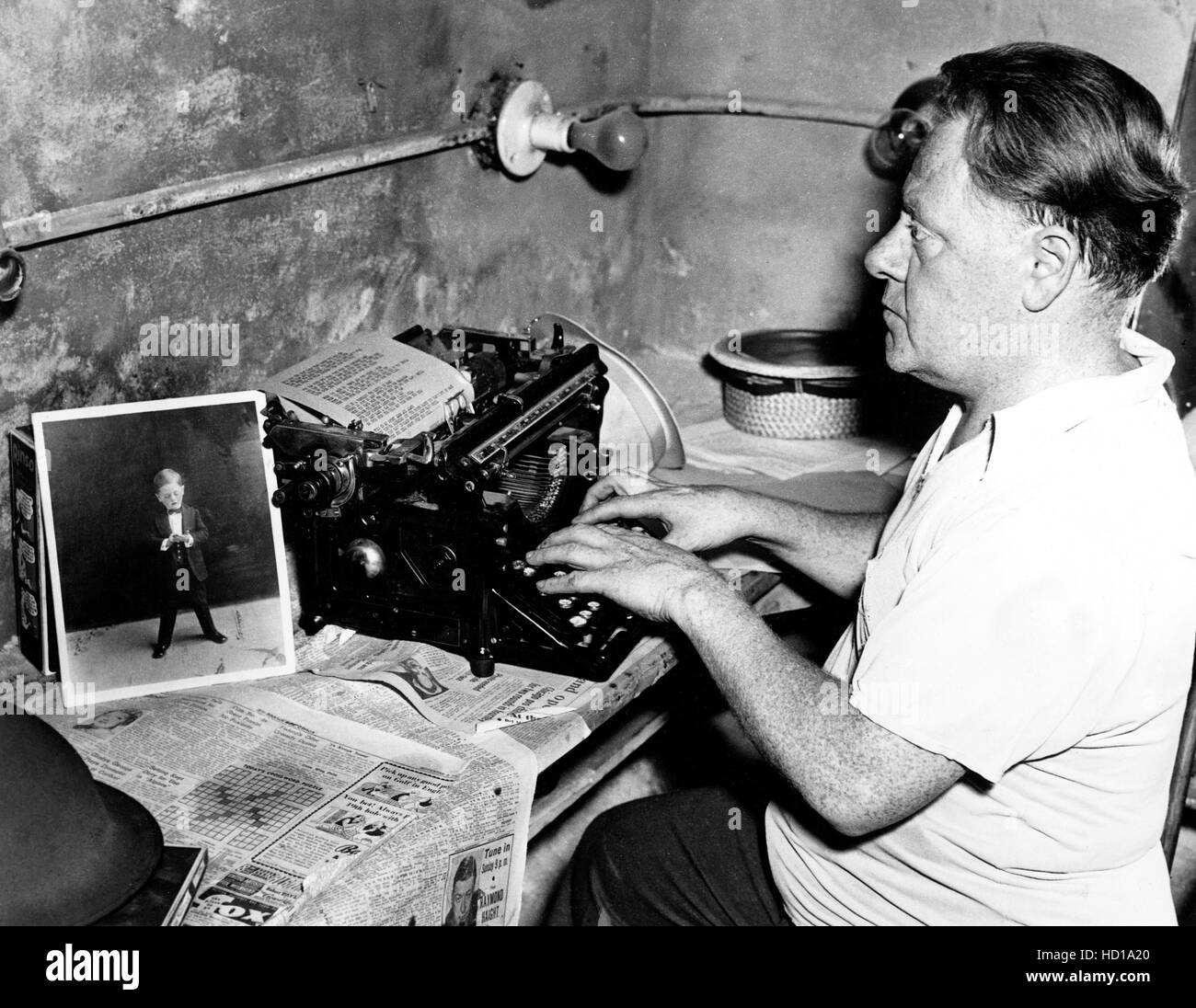Joe Yule, typing with a picture of his son, Mickey Rooney, 1939 Stock ...