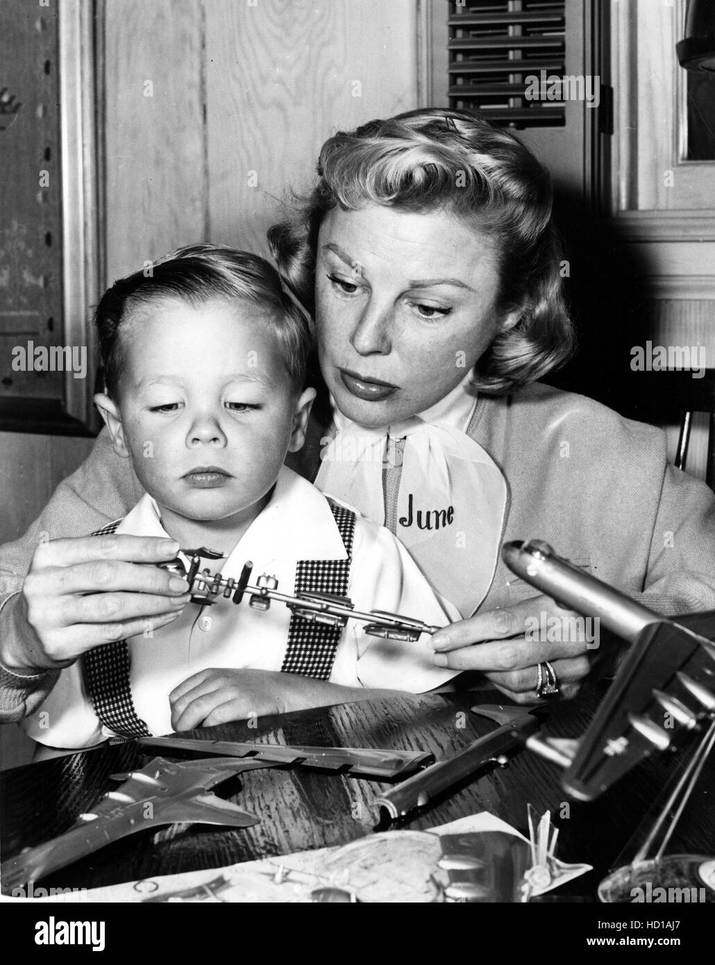 Five year old DICK POWELL, JR. gets a hand from mom JUNE ALLYSON as ...