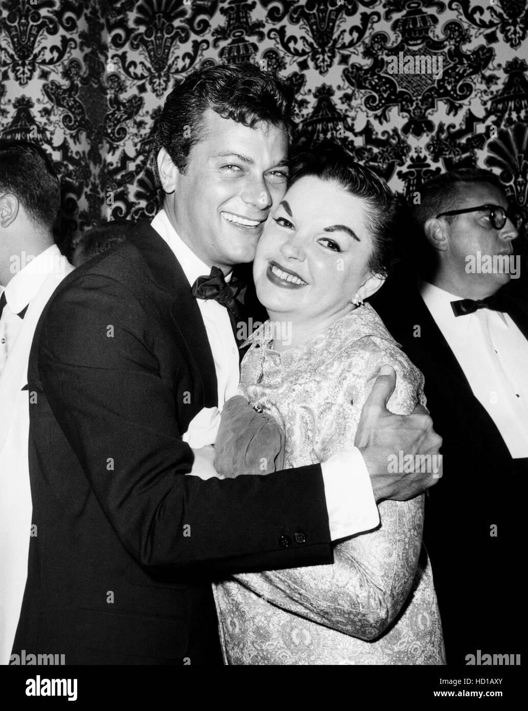 Tony Curtis, left, hugging Judy Garland, who is ill with a kidney ...