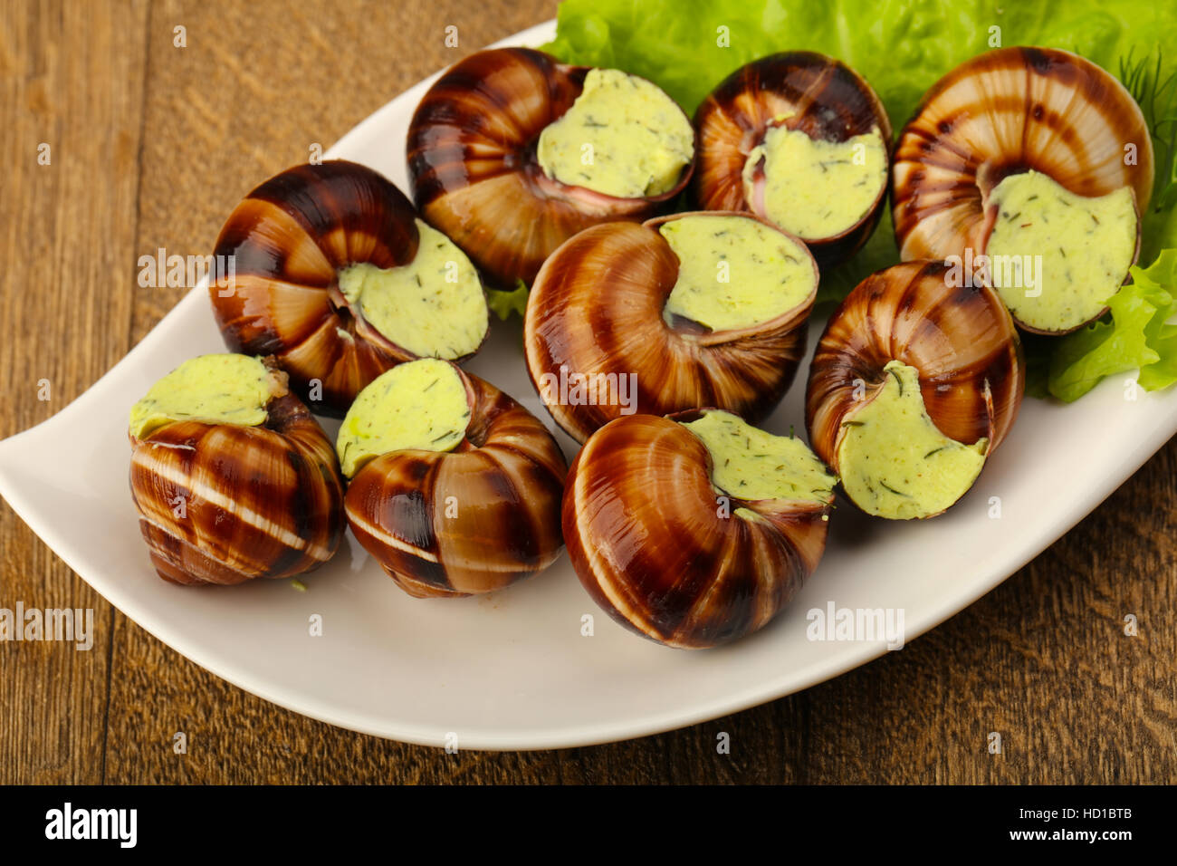 Escargot with cheese cream on salad leaves Stock Photo - Alamy