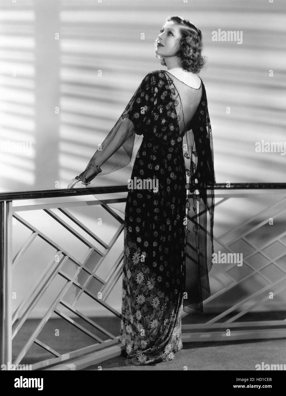 Loretta Young, in a silk and net dinner dress, ca. 1937 Stock Photo - Alamy