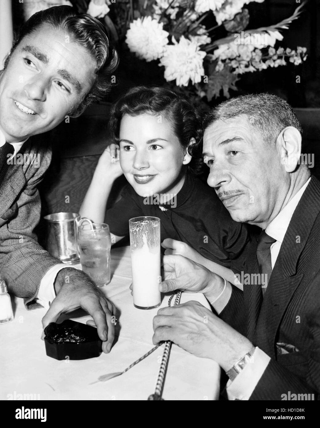 Peter Lawford, left, greets restaurateur Michael Romanoff, right, and ...
