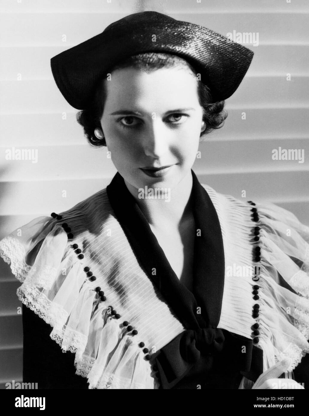 Mona Barrie, modeling an afternoon forck with a glazed straw hat by ...
