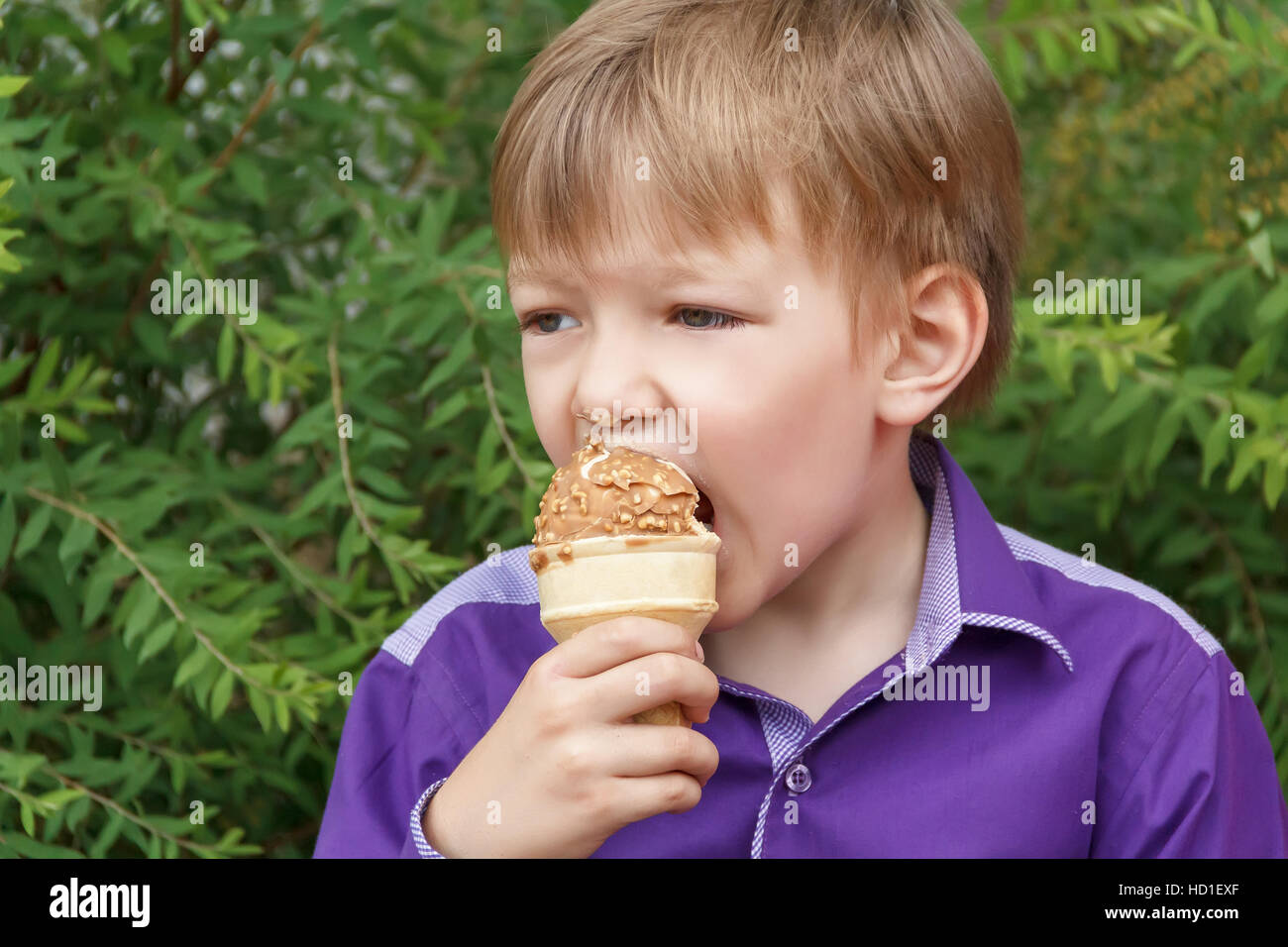 Photo of blond child eating icecream in summer Stock Photo - Alamy