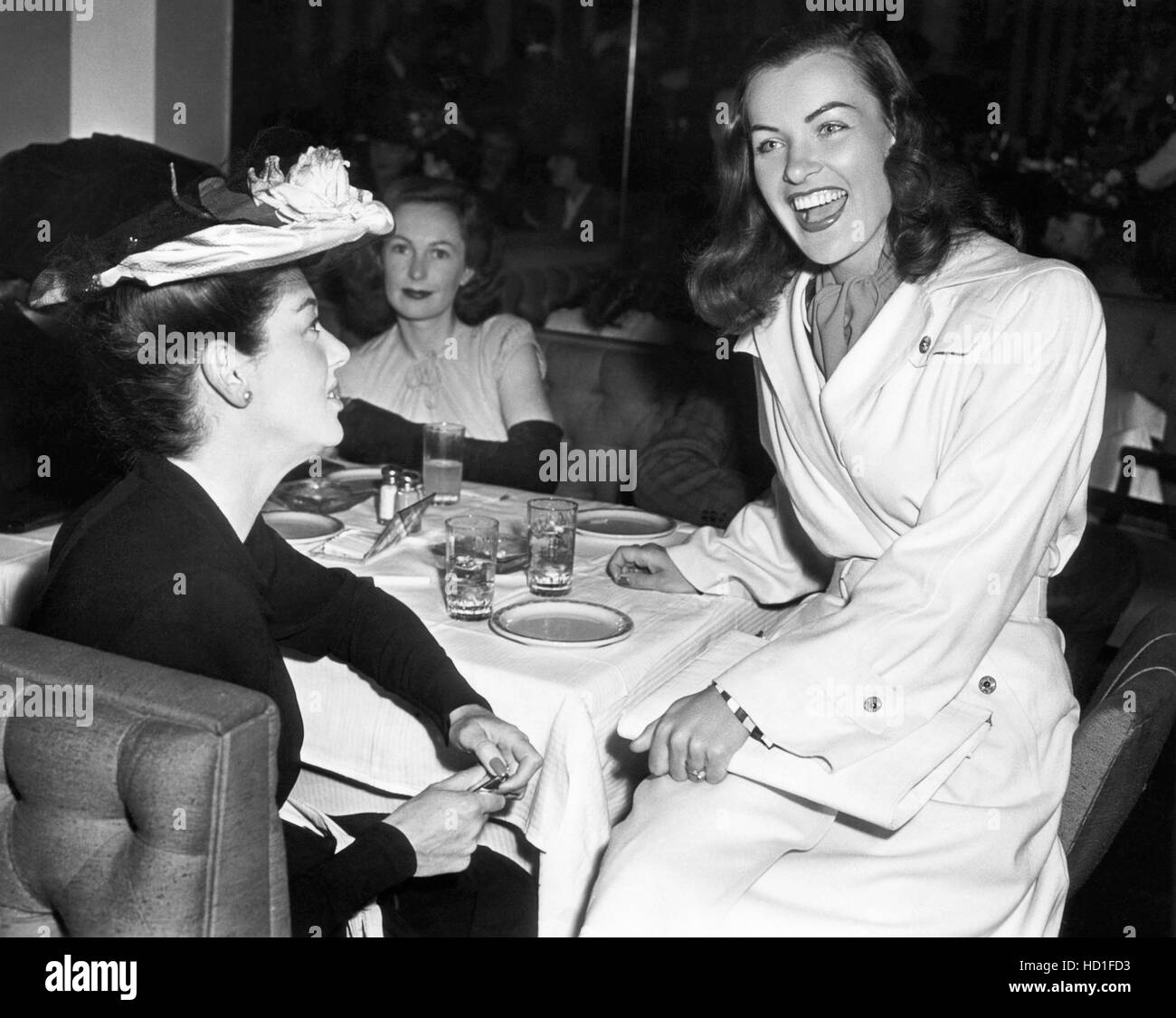Rosalind Russell, Geraldine Fitzgerald, Ella Raines (right) at a tea ...