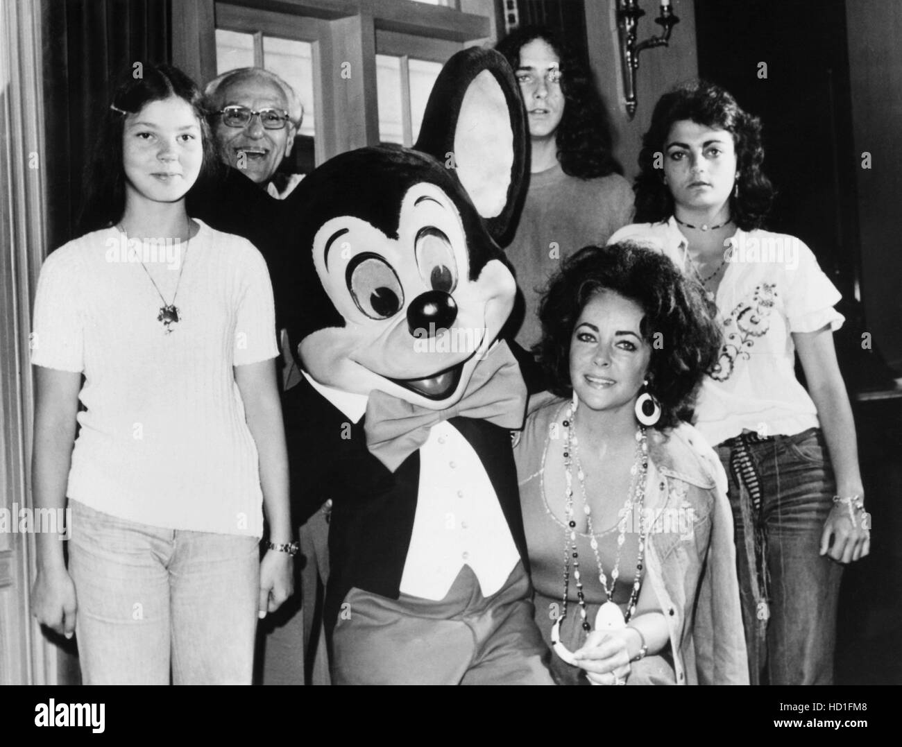 From left, Maria Burton, George Cukor, Mickey Mouse, Christopher ...