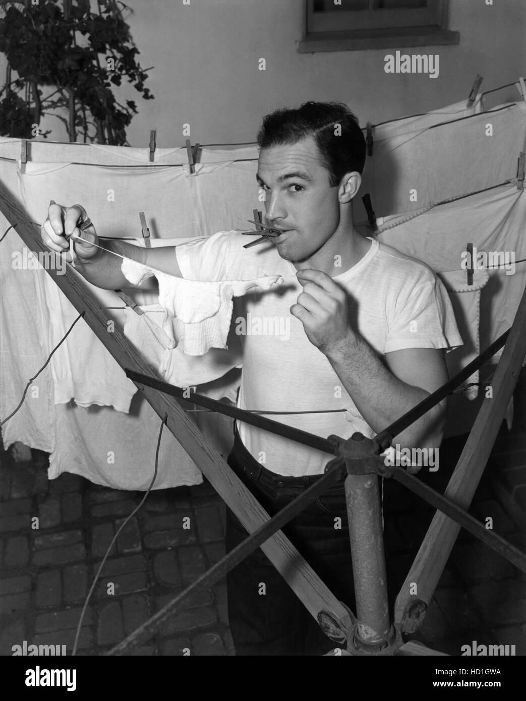 Gene Kelly helps around the house hanging up his daughter's laundry ...