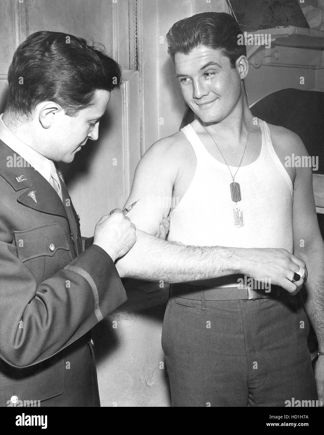Sgt.George Reeves (right) receives shot from Lt. William G. Cahan on ...