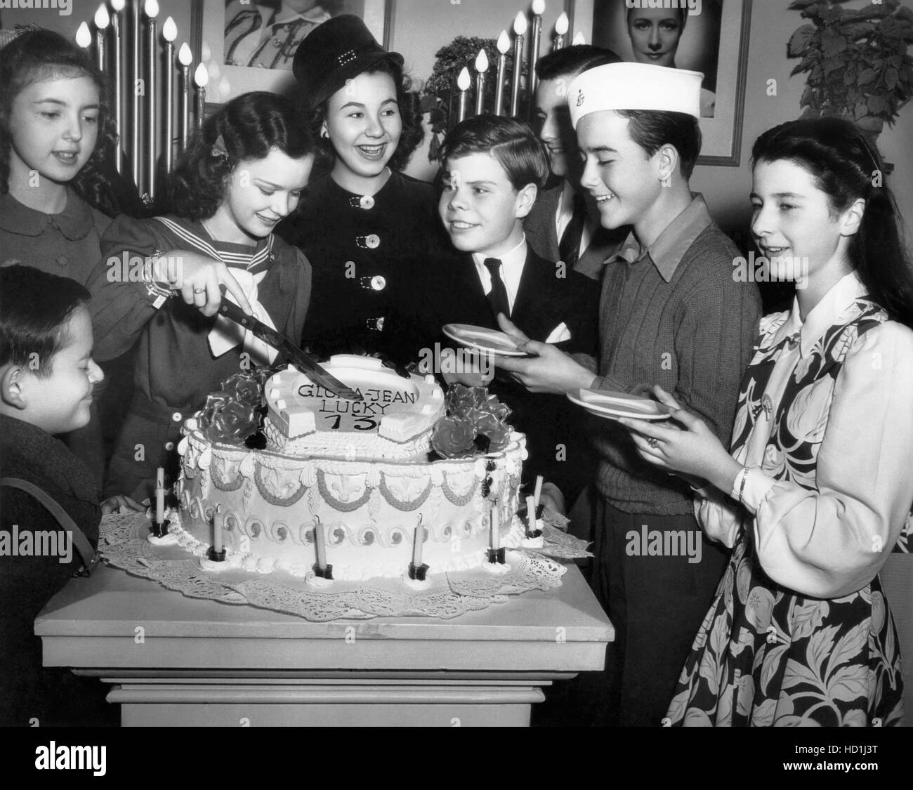 Gloria Jean, (third from left) cuts her 13th birthday cake for child ...