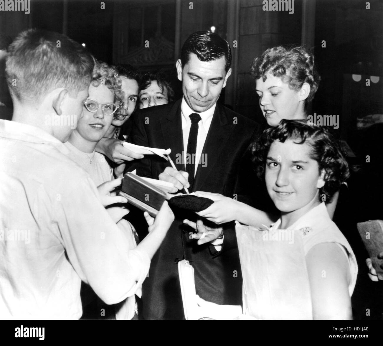 Jack Webb signing autographs for fans, Chicago, Illinois, 1954 Stock ...