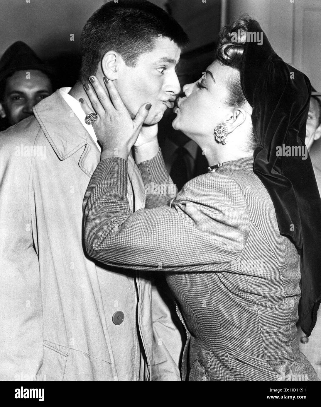 JERRY LEWIS gets a Latin kiss from co-star CARMEN MIRANDA during ...