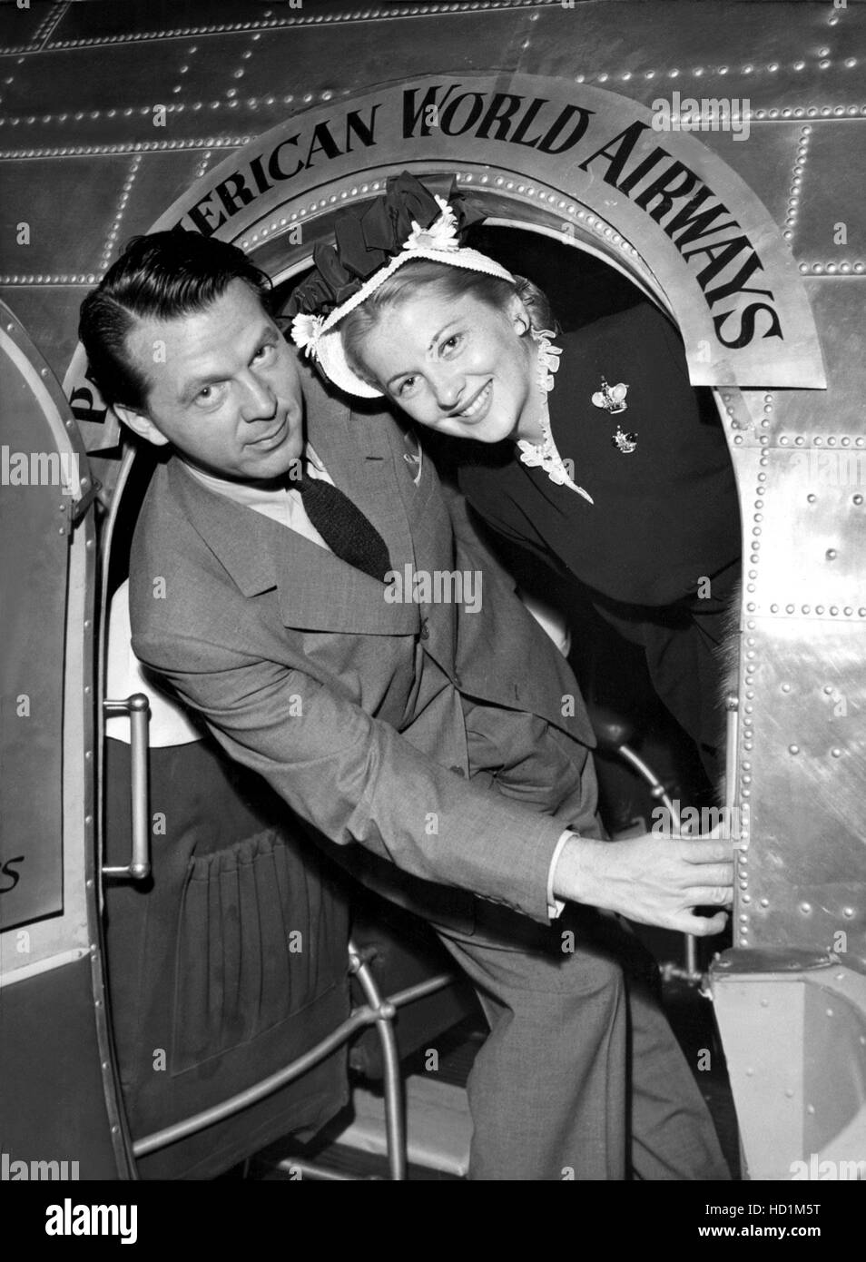 Producer WILLIAM DOZIER and Fiance JOAN FONTAINE board a Pan-Am flight to Mexico, where they ...