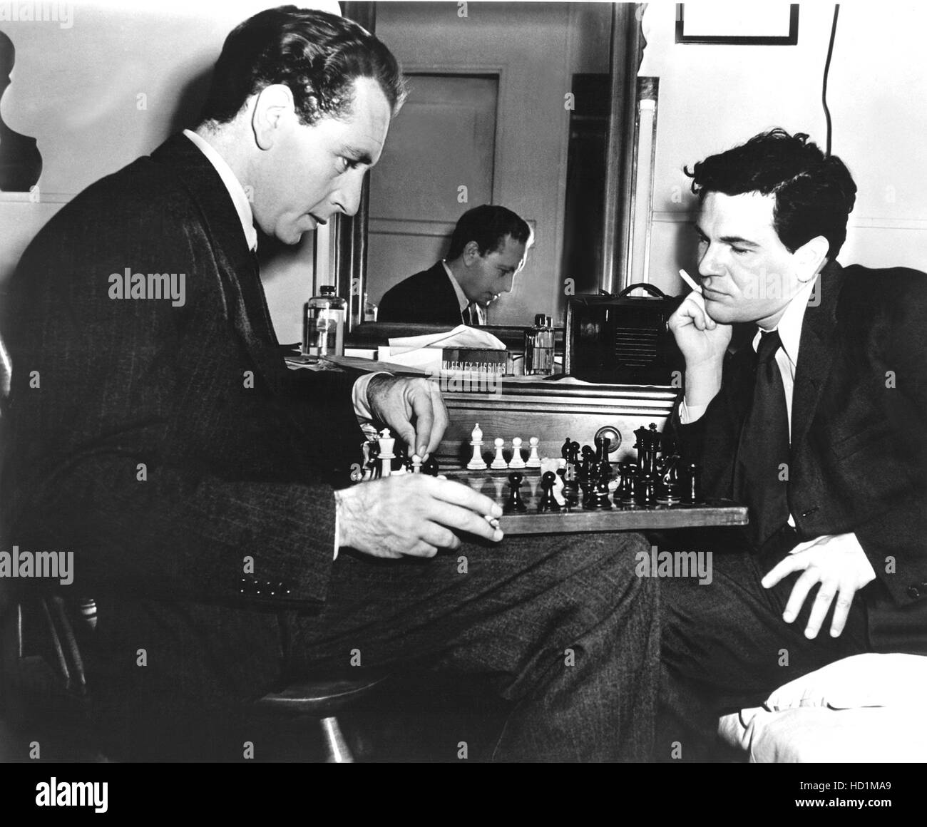 BETWEEN TWO WORLDS, Paul Henreid, John Garfield, playing chess, on-set ...