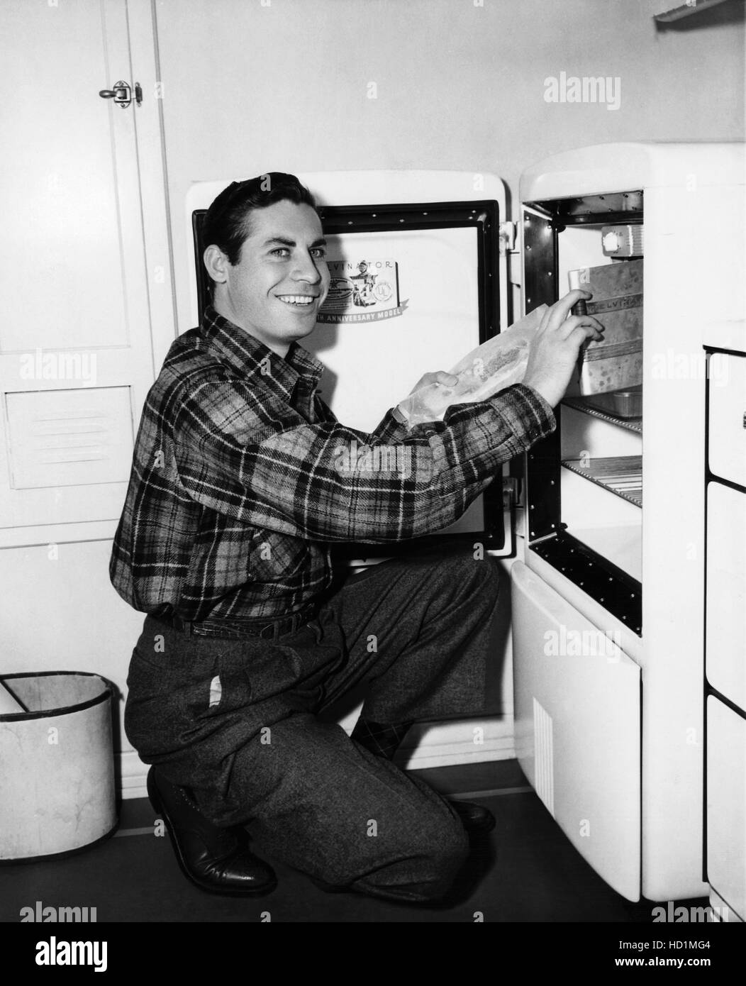 John Hodiak making dinner at home, Beverly Hills, California, 1944 ...
