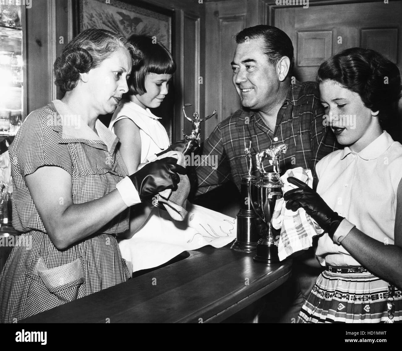 Johnny Mack Brown, beaming while his wife, Cornelia Brown, and their daughters, Sally Brown and ...