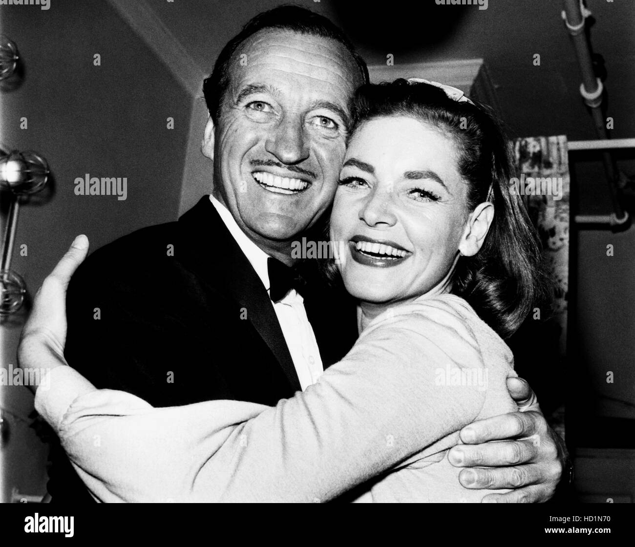 David Niven (left) embraces Lauren Bacall backstage after her opening ...
