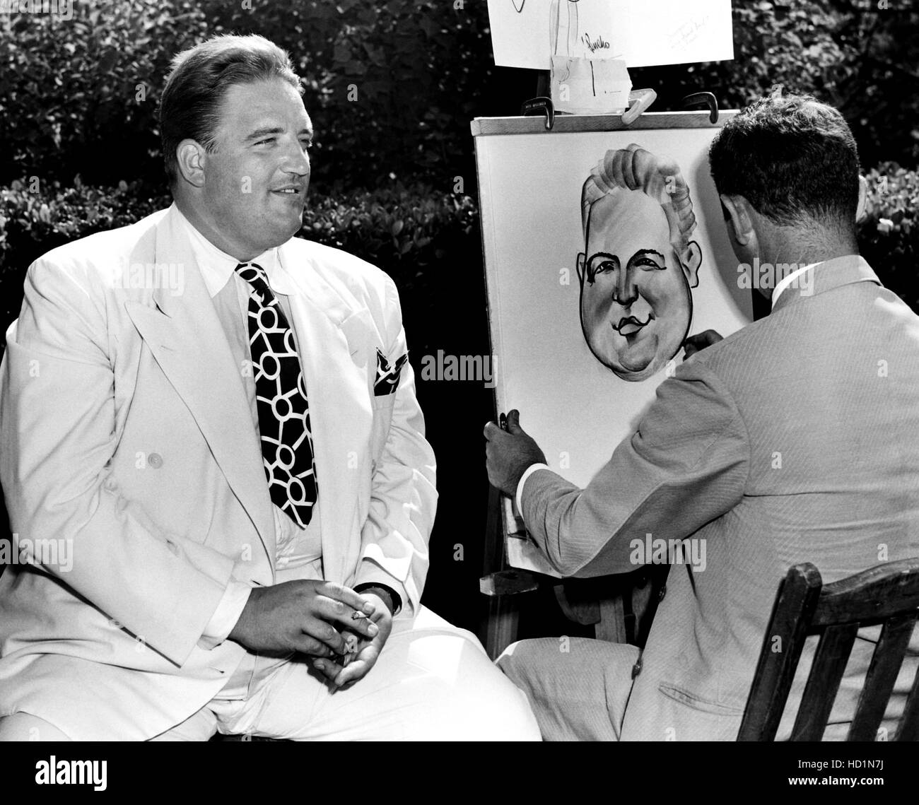 Laird Cregar has his caricature sketched at the Free French party at ...