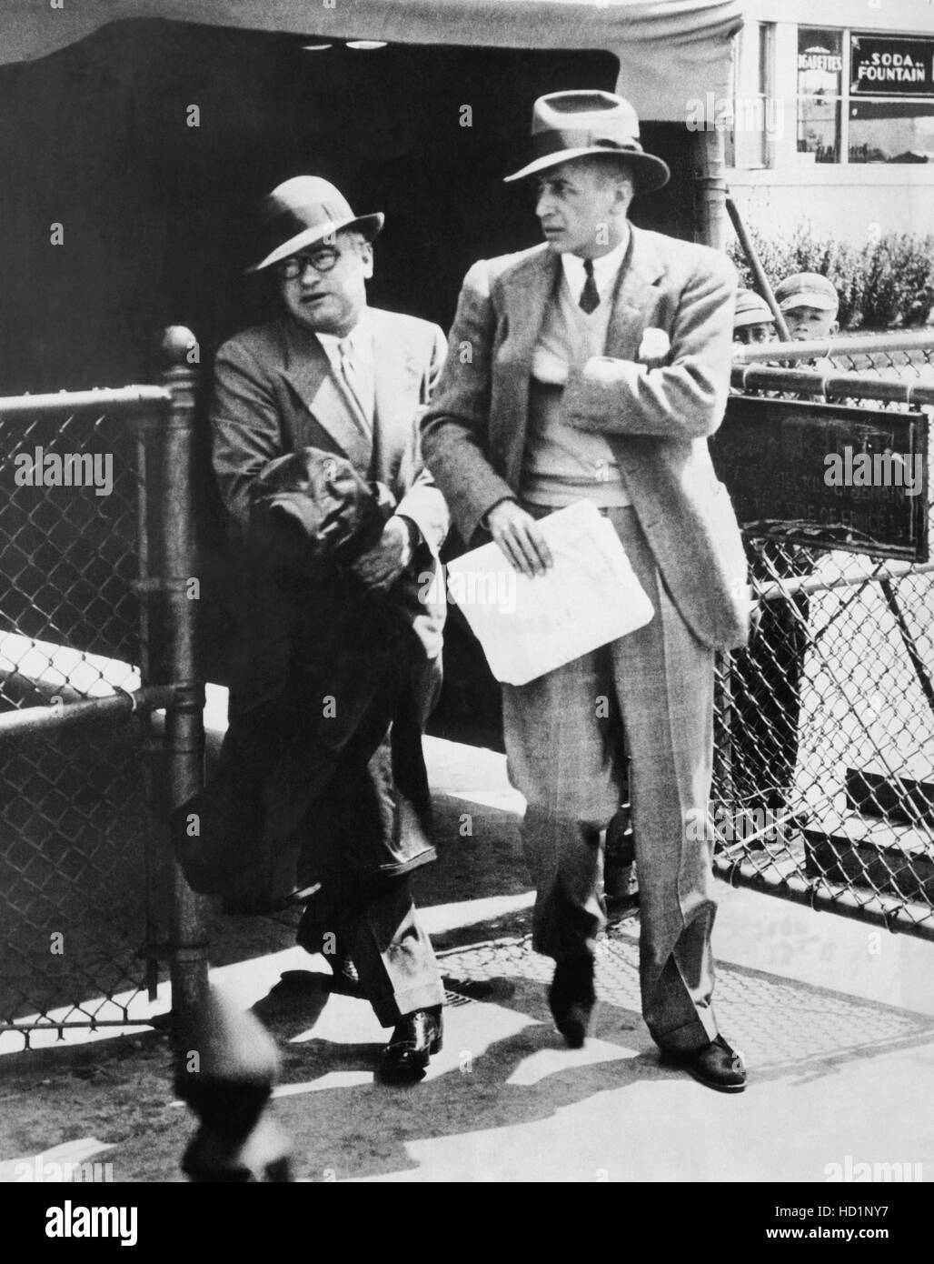 Producers Leland Hayward, right, and Myron Selznick, dodging reporters ...