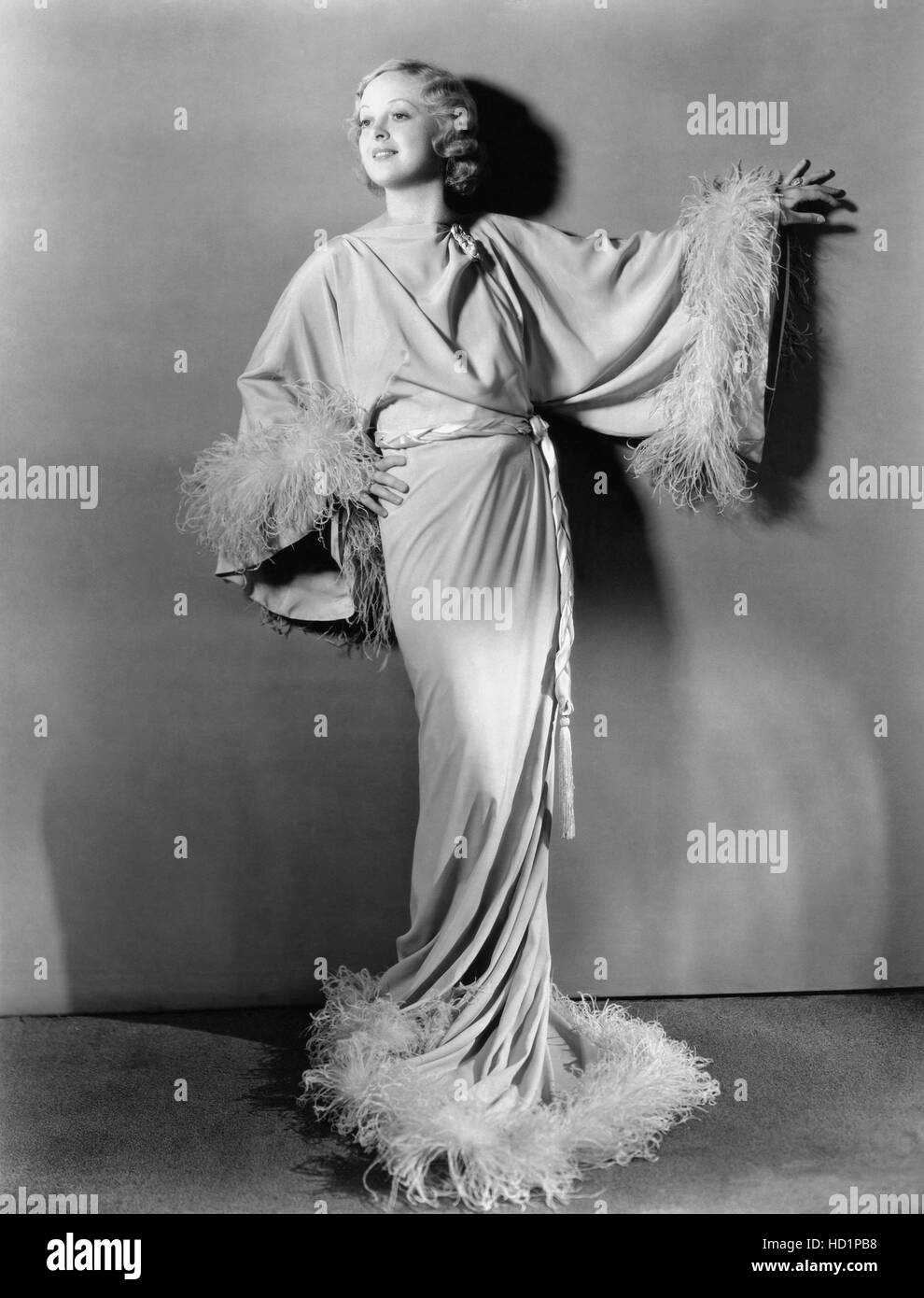 MGM starlet Lillian Ellis, in a green crepe dressing gown trimmed in ...