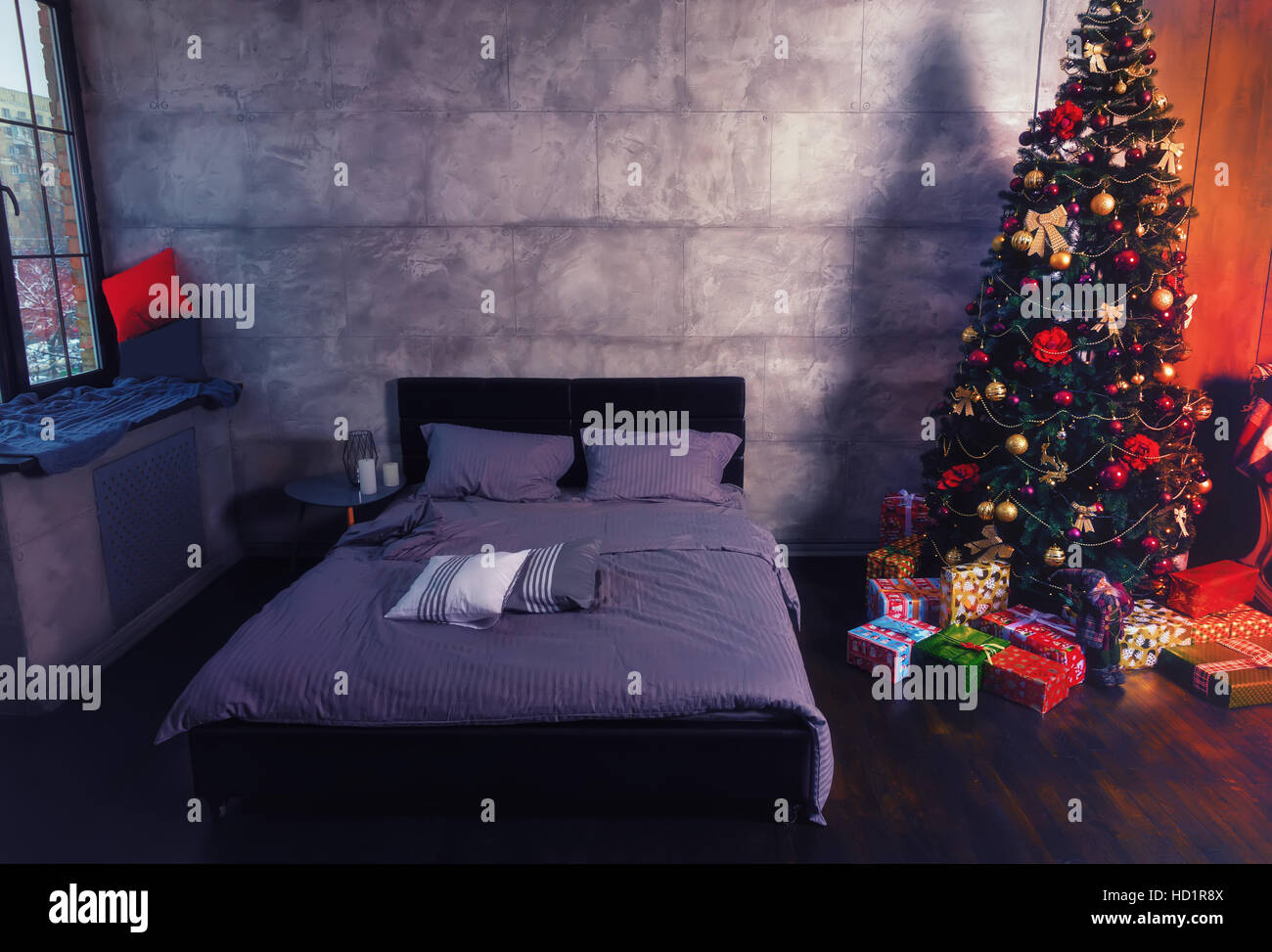 Stylish empty bedroom in loft style with grey colors and Christmas tree ...