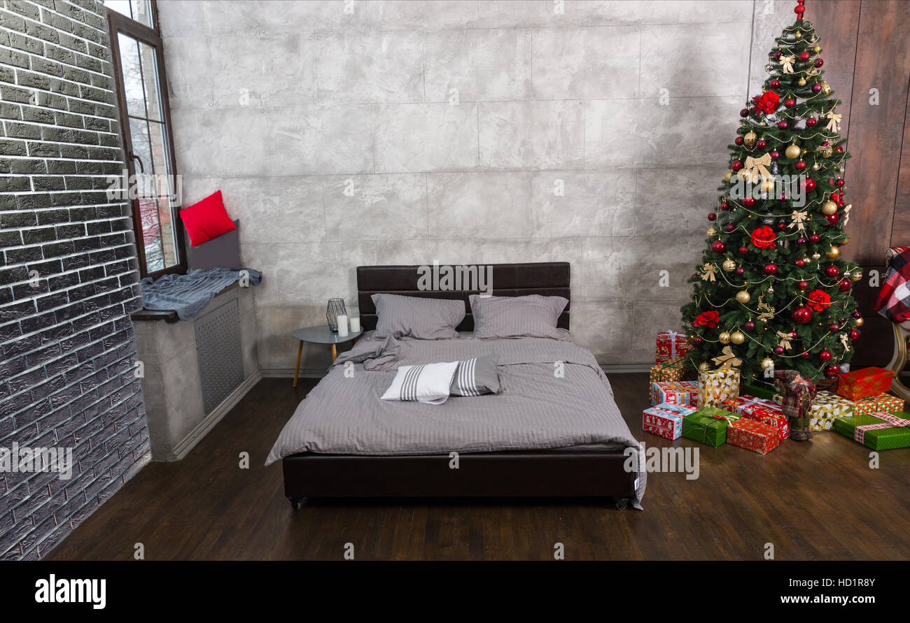 Modern empty bedroom in loft style with grey colors and Christmas tree ...