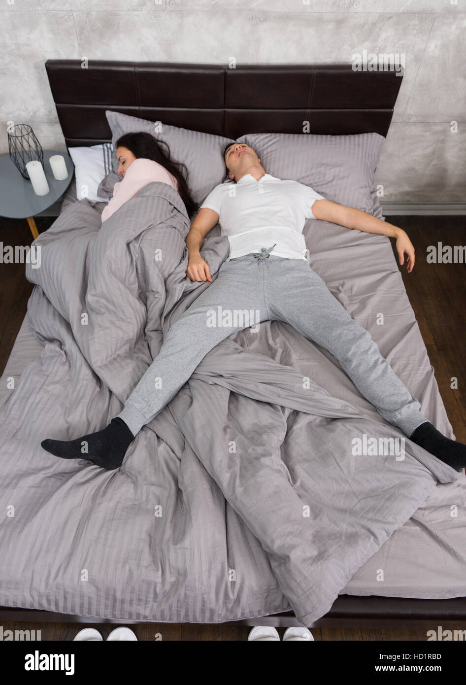 Young man sleeping in free fall position with his girlfriend occupied ...