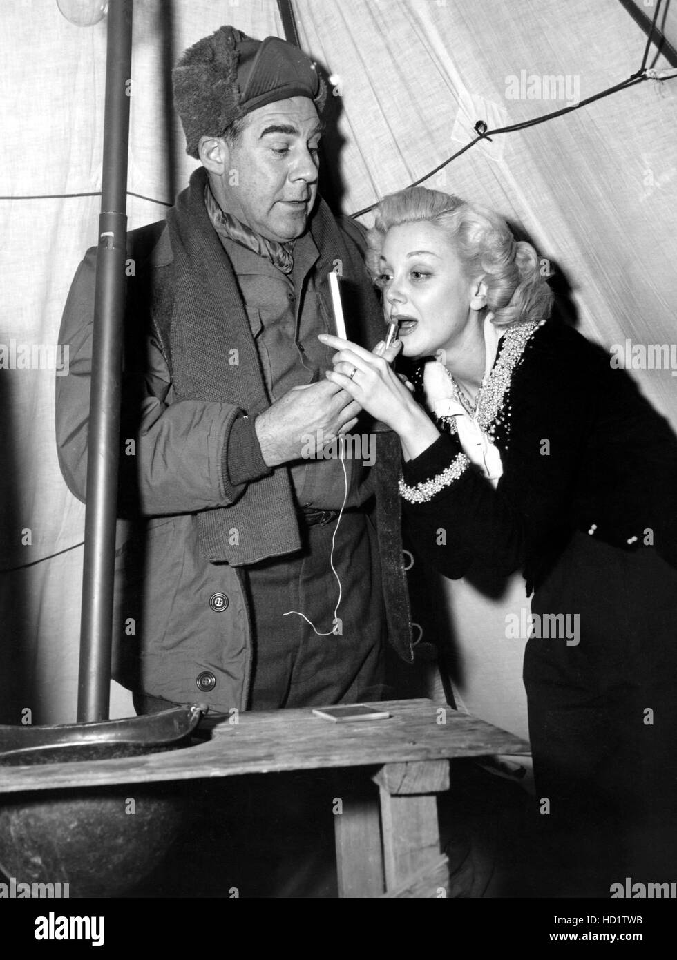 From left: Paul Douglas helping wife Jan Sterling get ready for USO show in Korea, ca. 1951 ...