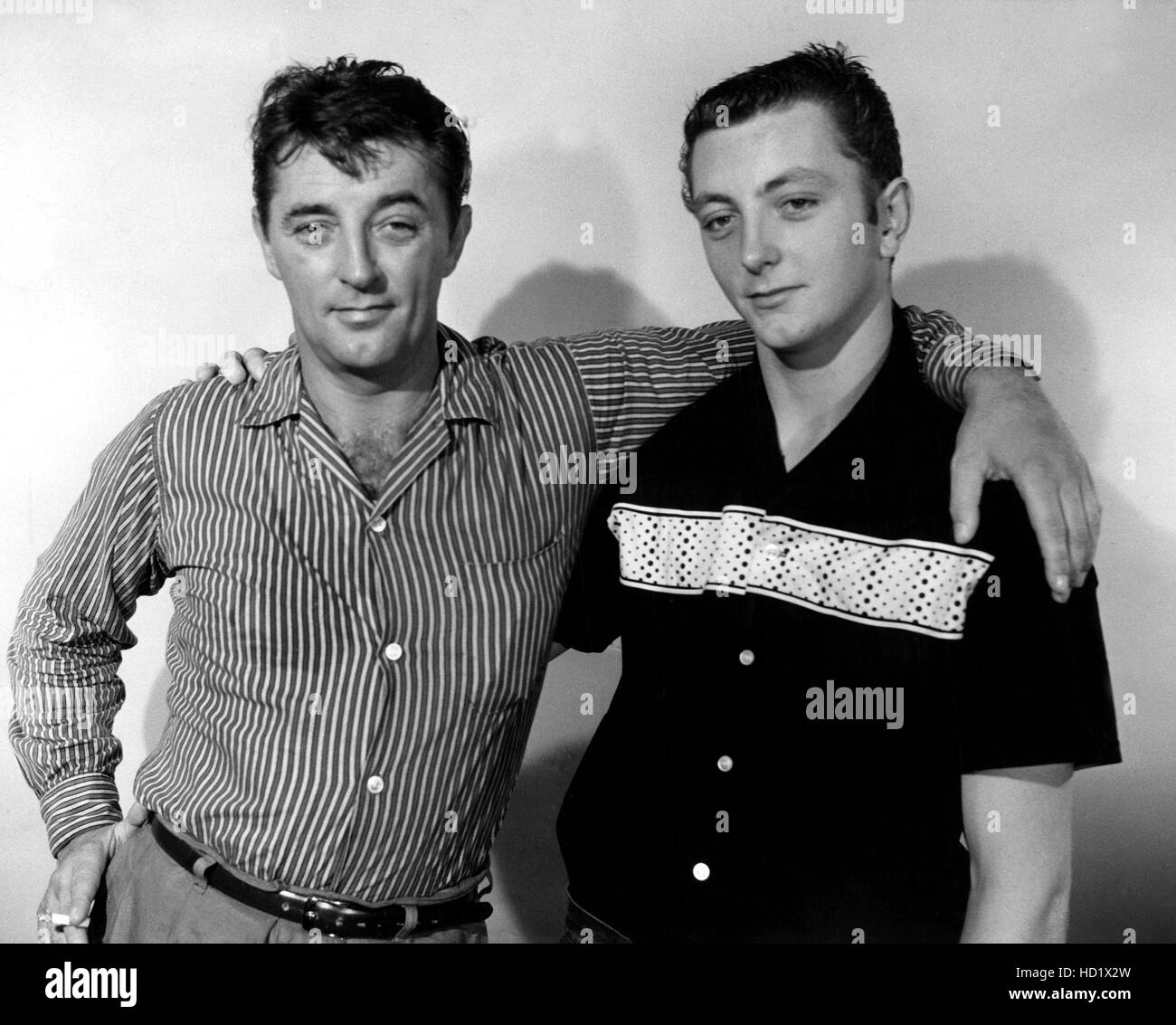 ROBERT MITCHUM and son JIM MITCHUM pose on the set of THUNDER ROAD ...
