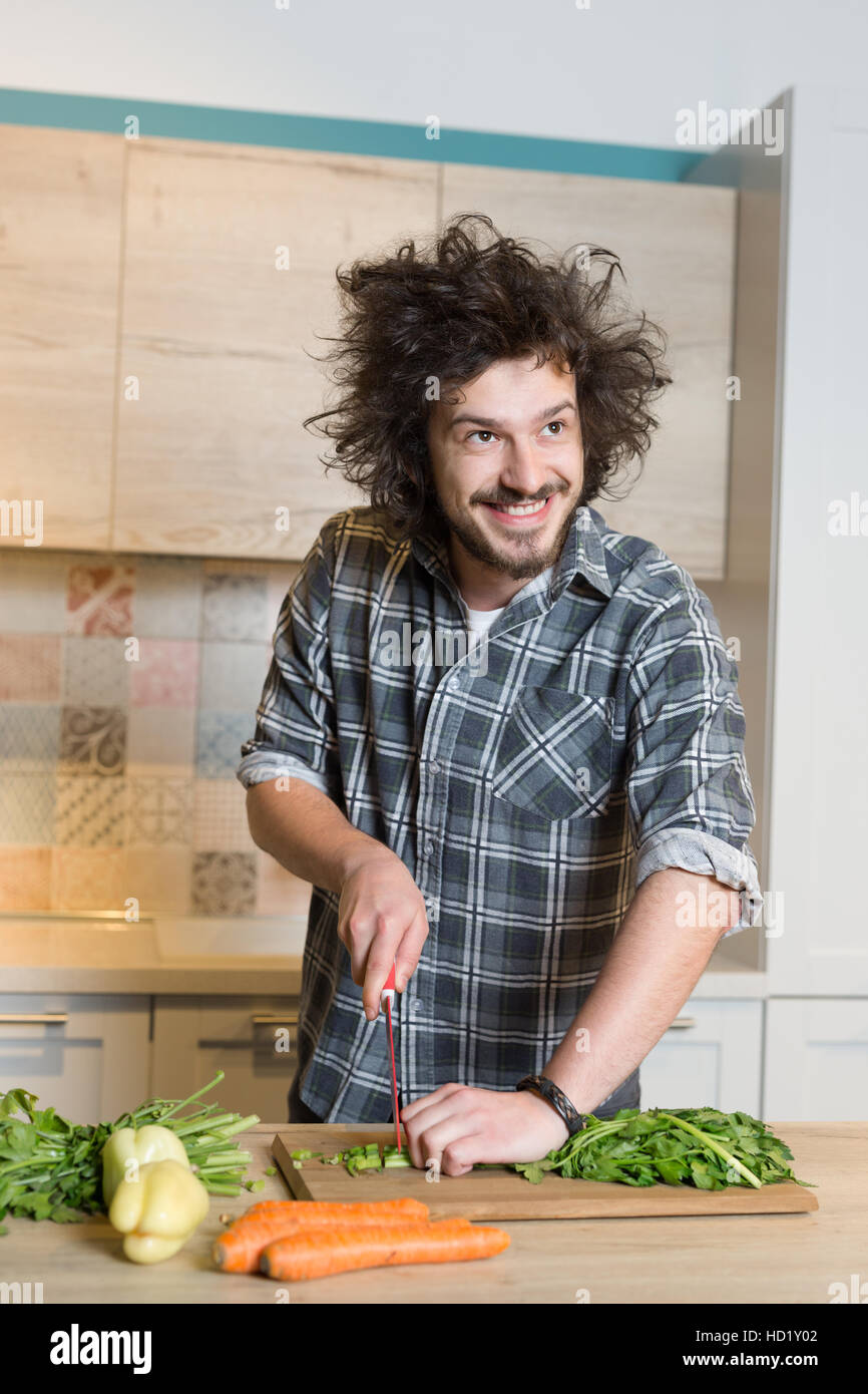 Man cooking in rustic kitchen Stock Photo - Alamy