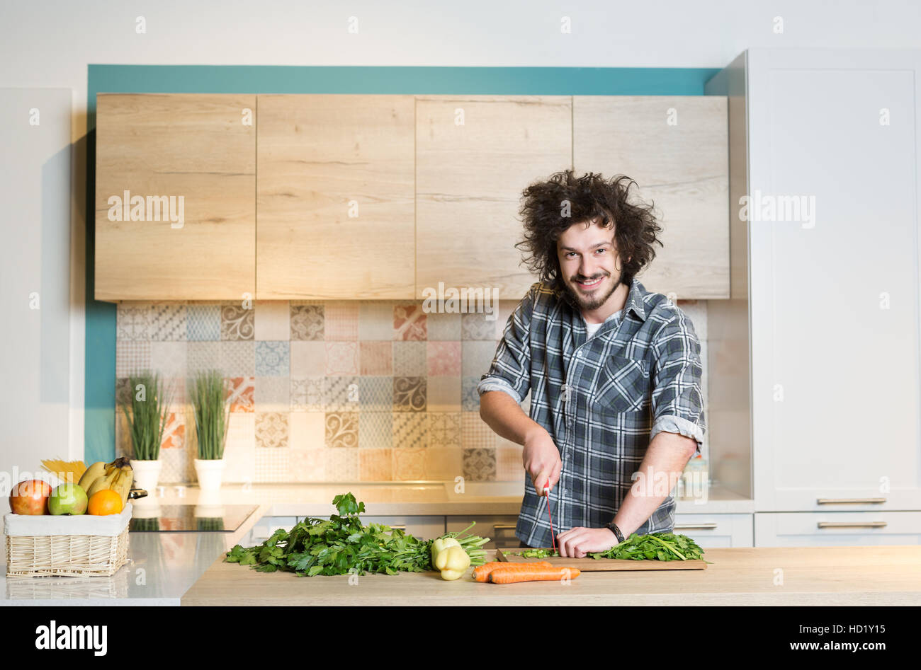 Man cooking in rustic kitchen Stock Photo - Alamy