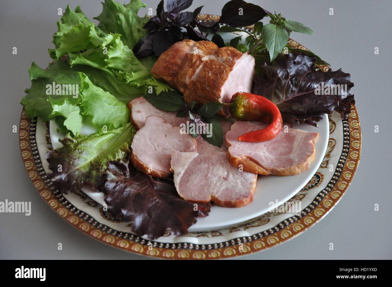 Pieces of meat with fresh herbs on the dining table Stock Photo - Alamy