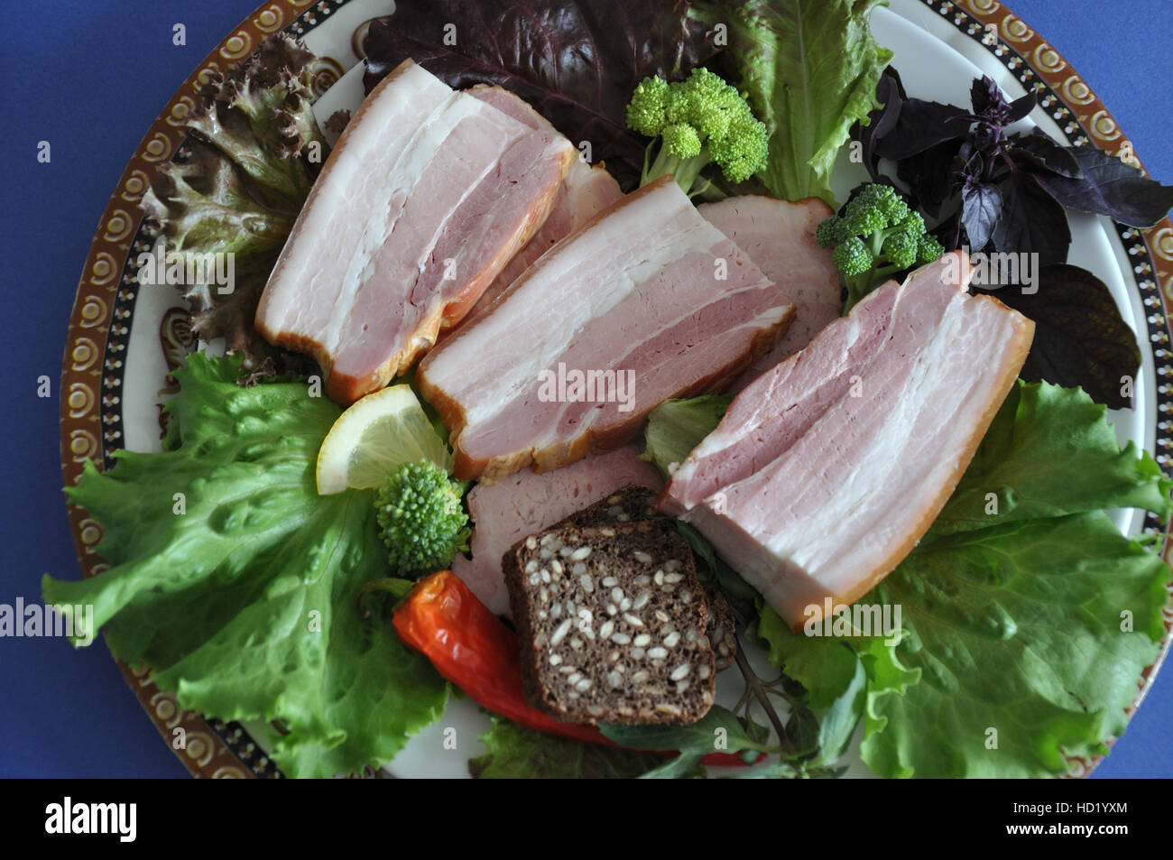 Pieces of meat with fresh herbs on the dining table Stock Photo - Alamy