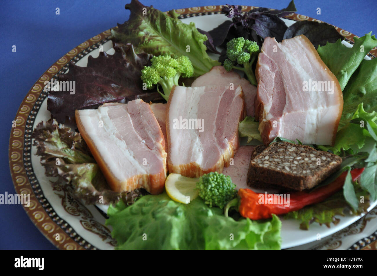 Pieces of meat with fresh herbs on the dining table Stock Photo - Alamy