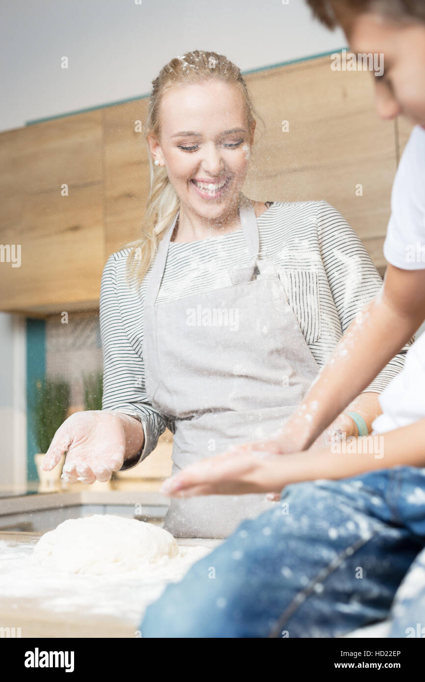 mother and son playing in kitchen with flour, flour fight Stock Photo ...