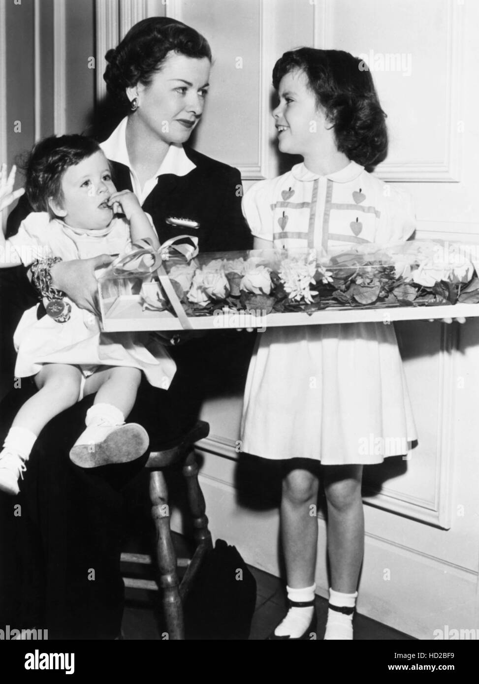 Joan Bennett acepting flower box from daughter Stephanie Wanger while ...