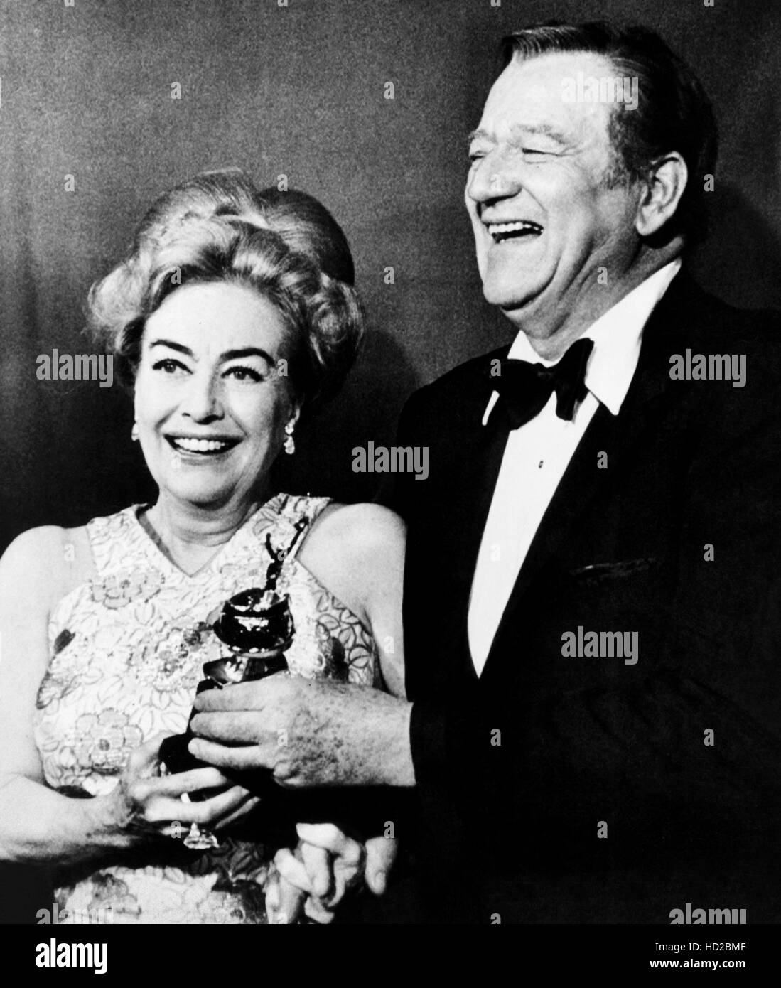 John Wayne, right, presents Joan Crawford with a Cecil B. DeMille Award ...