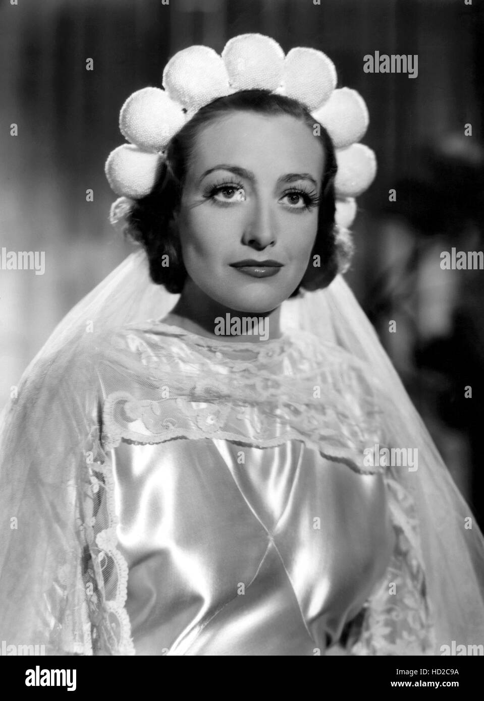 Joan Crawford wearing a seed pearl coronet headpiece designed by Adrian ...